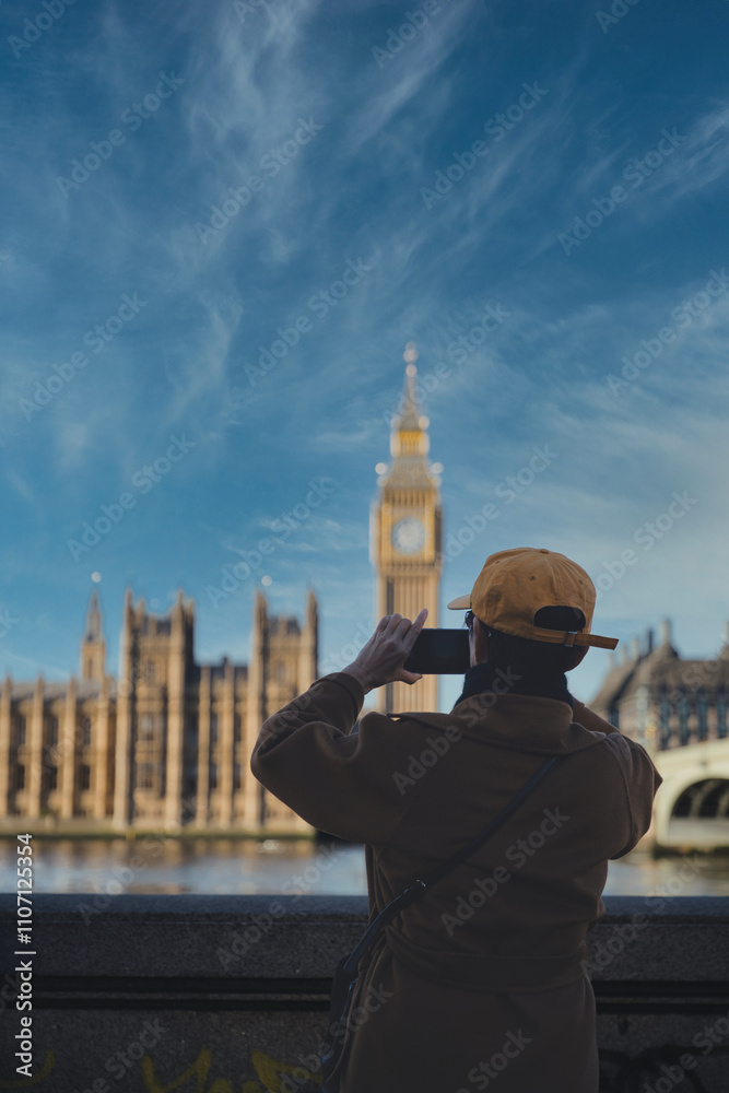 Man tourist is taking pictures of big ben and the palace of westminster ...