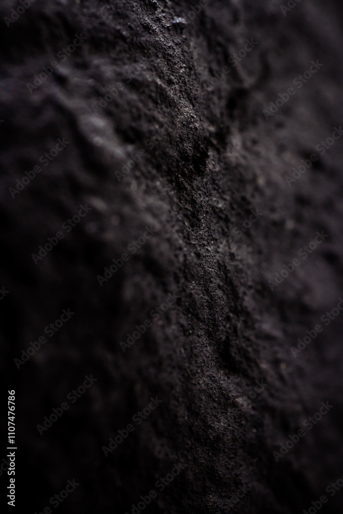 Extreme close up of painted in black handmade paper clay with a ...