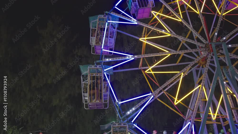 Ferris wheel at night of colorful neon light with outdoor round ...