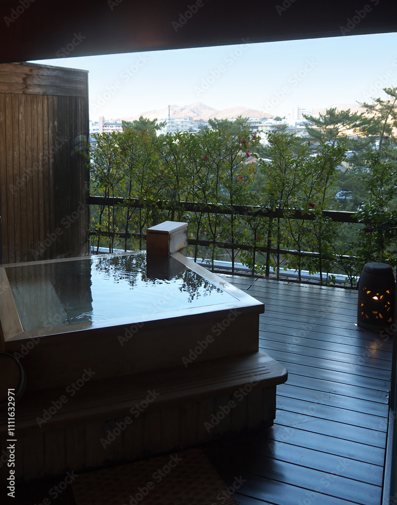 Japanese onsen private open air wooden bath with city view and reflections in the water Stock ...