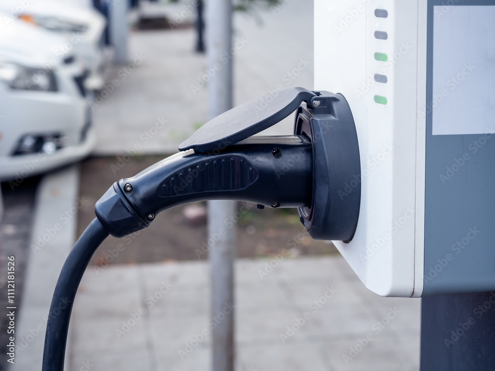 EV car charger handle plugged in, electric vehicle charging cable ...
