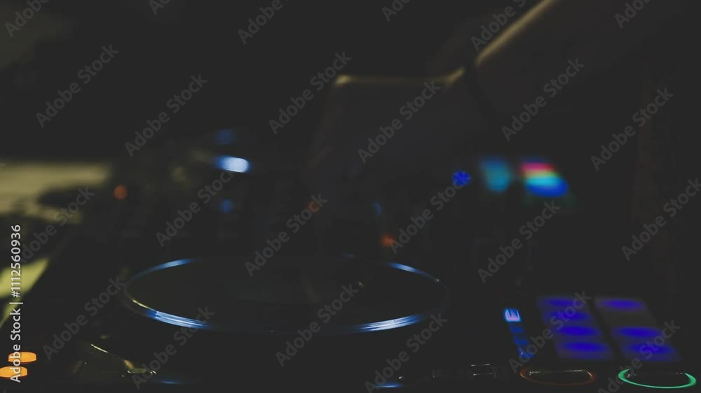 DJ work in a nightclub, mixing and dancing. A club DJ mixes music using ...