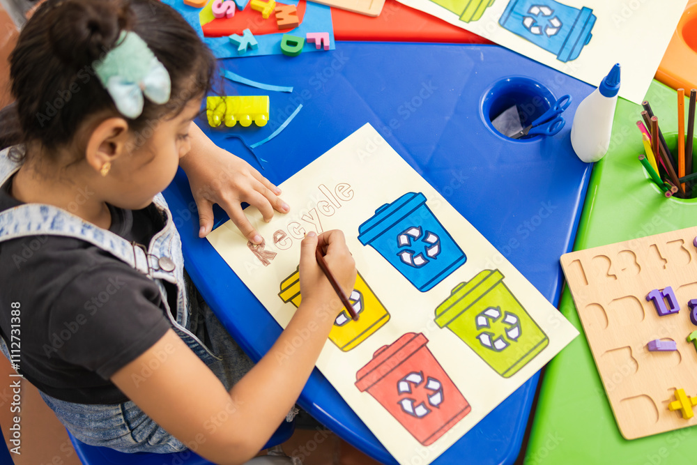 Latin girl in a primary school classroom, writing and painting the word ...