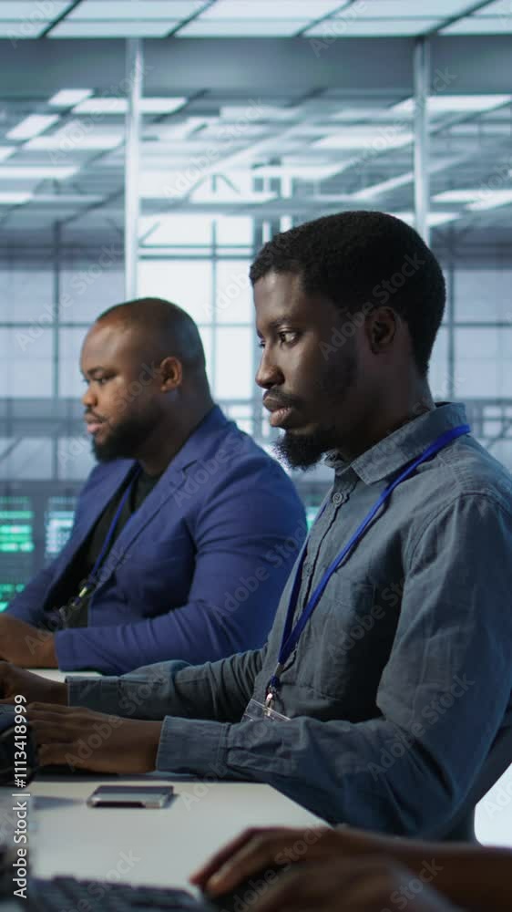 Vertical video System administrators in data center implementing AI predictive maintenance ...