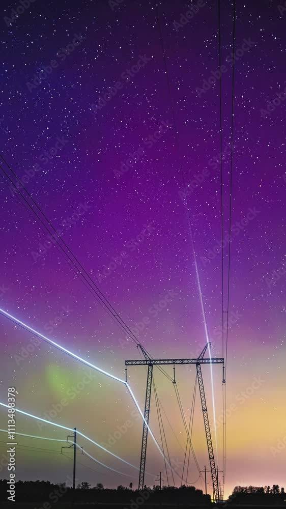 High capacity transmission tower on a starry night with aurora borealis ...