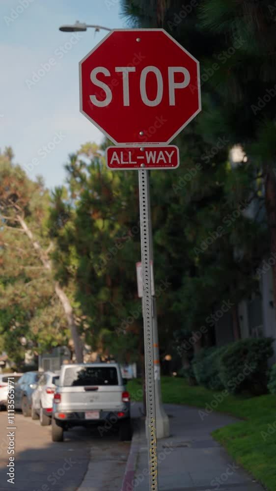 Red and white stop sign on a side road Bright and reflective colors of ...
