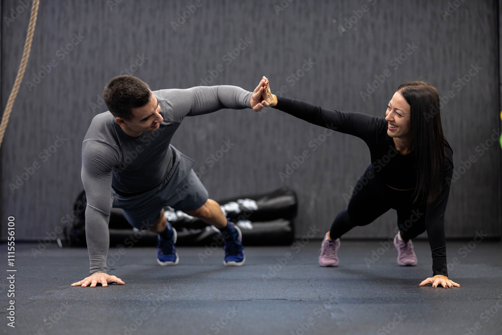 Photo & Art Print A man and woman do a synchronized high-five while ...