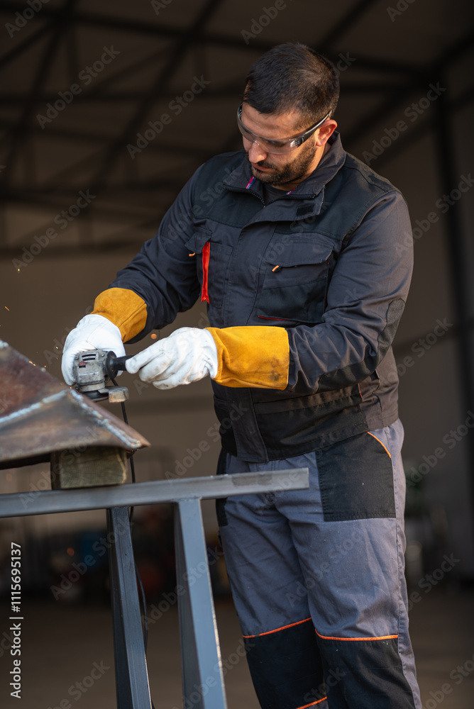 Metal worker using angle grinder while wearing safety glasses Stock ...