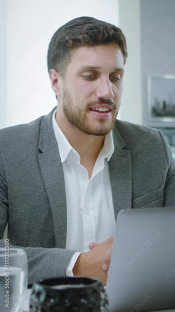Lateral dolly of happy caucasian young man in video conference call at ...