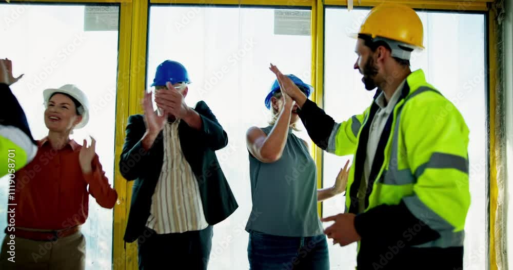 Construction, team and celebration with blueprint, teamwork and ...