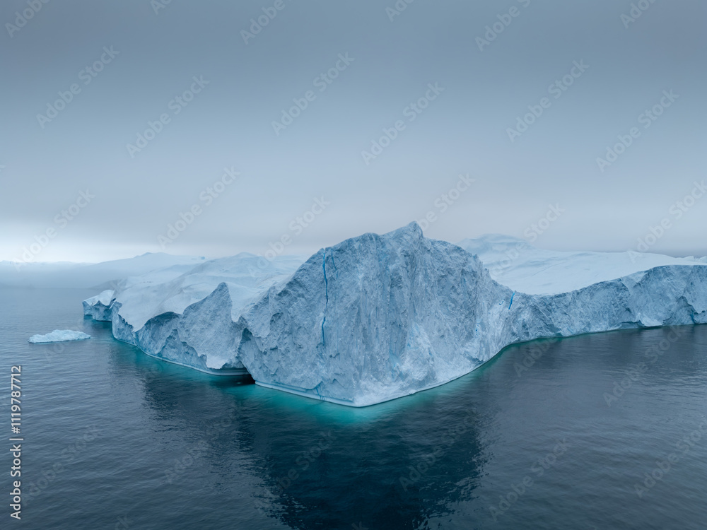 Moody view of huge icebergs floating at the horizon in the icefjord in ...