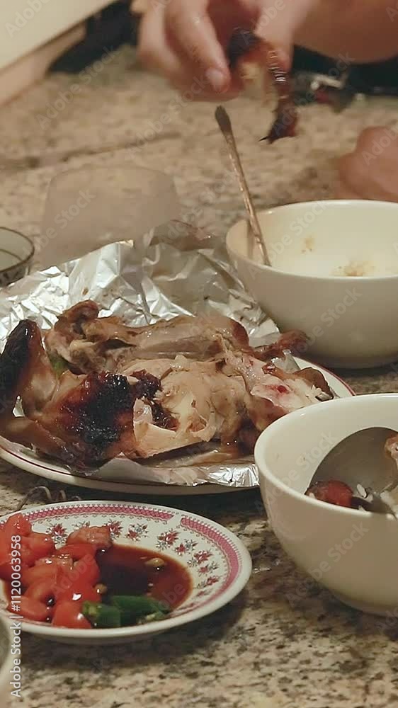 Eating lechon manok or roasted chicken with bare hands that shows a ...