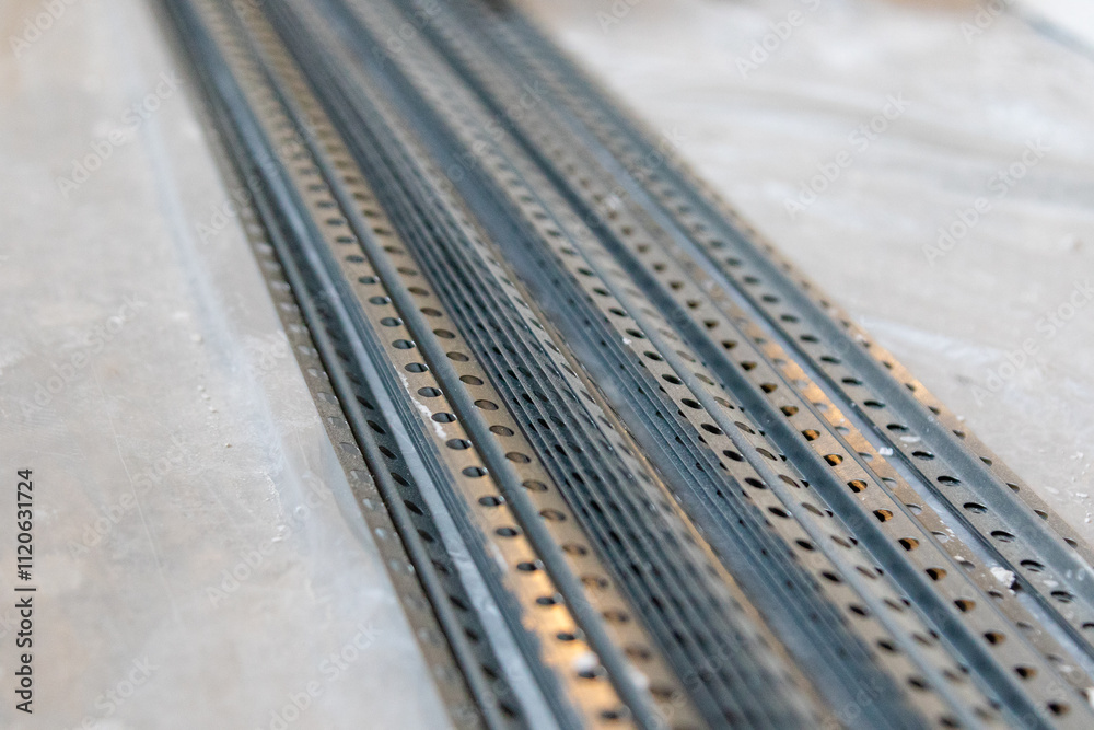 Plaster leveling guide profiles. Metal profiles with holes for smooth ...
