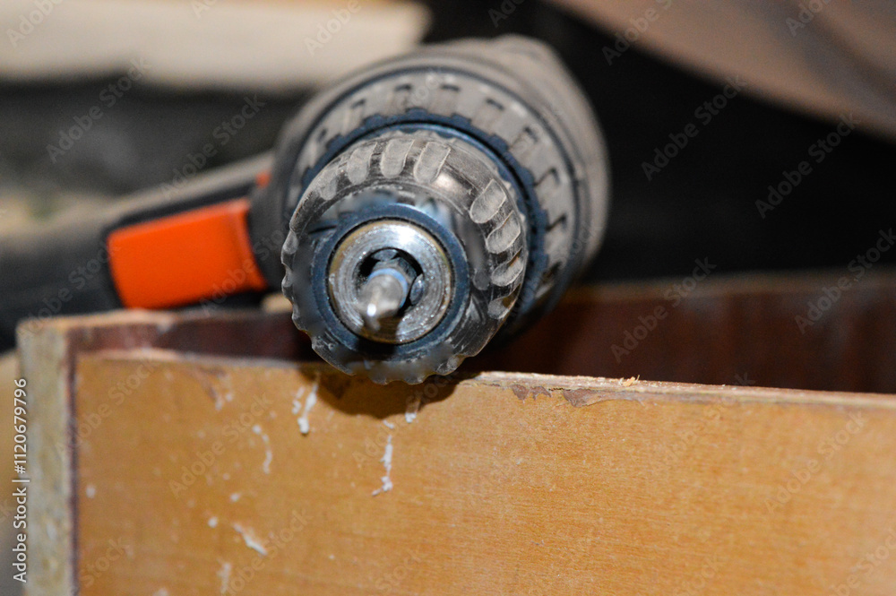 person using a power drill to fasten wooden boards together screwdriver ...