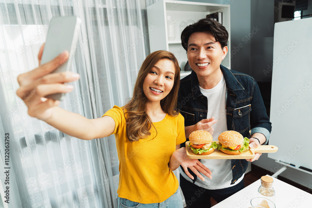 Smiling host chef influencers taking photo with smartphone by selfie ...
