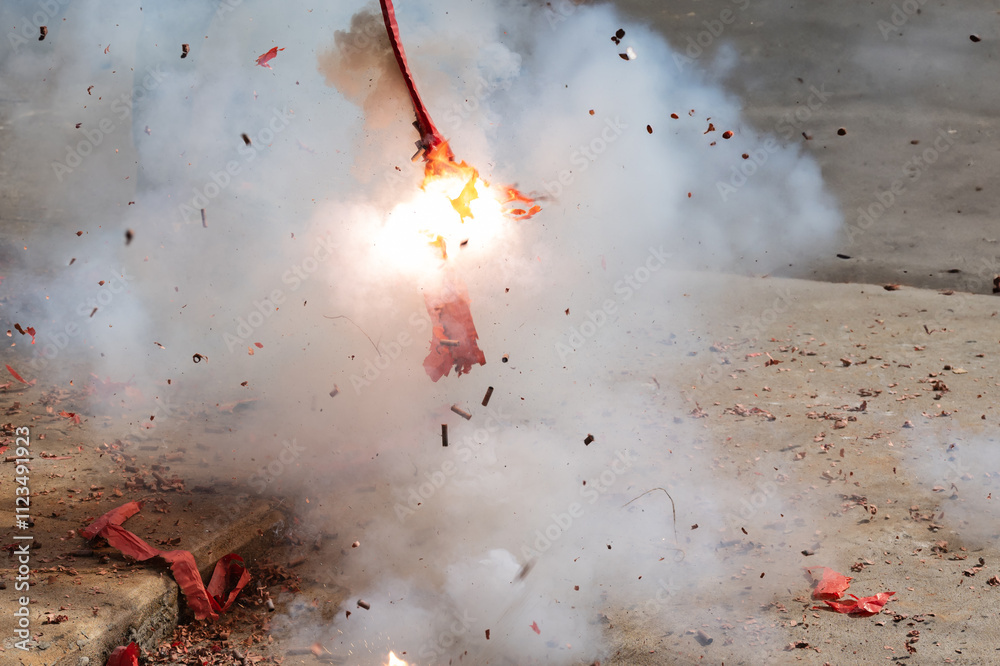 Red firecrackers exploding in the street for the chinese new year ...