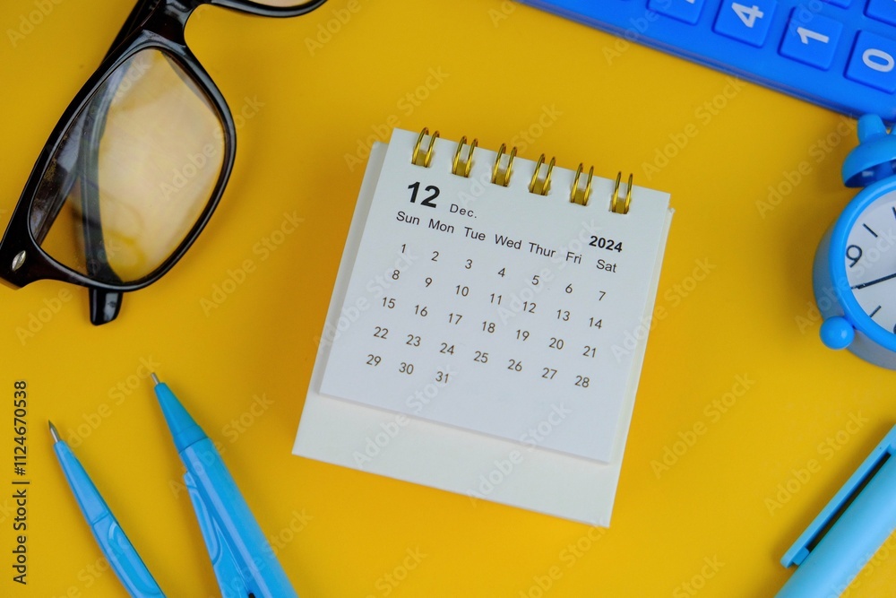 Monthly desk calendar for December 2024 year on yellow background with ...
