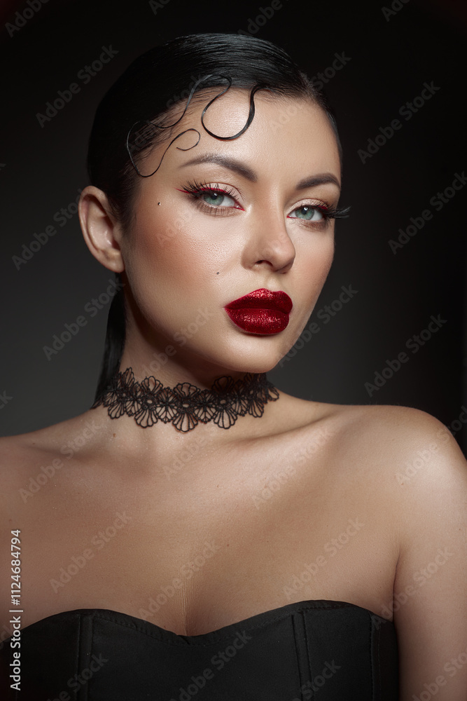 confident woman showcases bold red lips and dramatic eye makeup with ...
