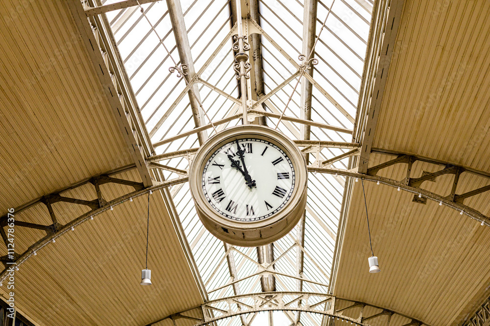a large clock suspended from the ceiling of a majestic building with a ...