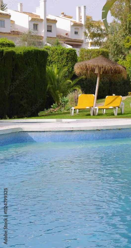 Portrait footage of a beautiful swimming pool in the summer time ...