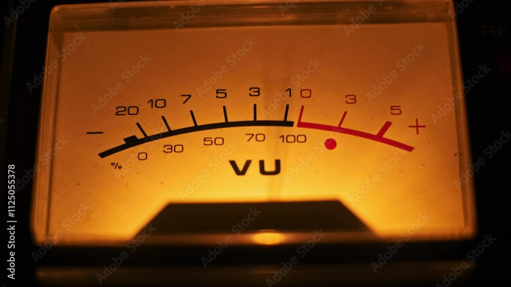 A vintage VU meter actively displays sound levels, its needle moving ...