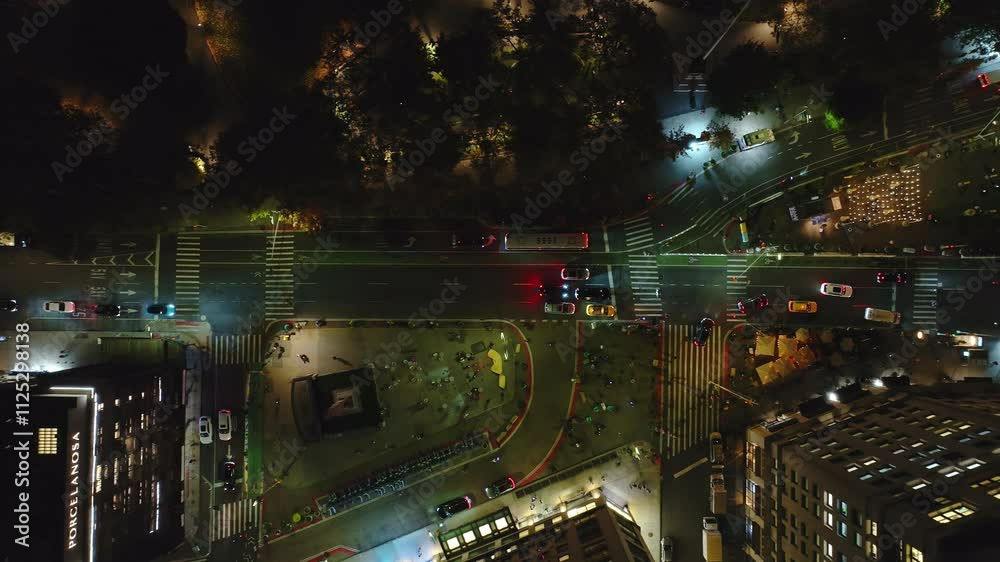Cars, buses, and yellow taxis navigate a busy intersection in Manhattan ...