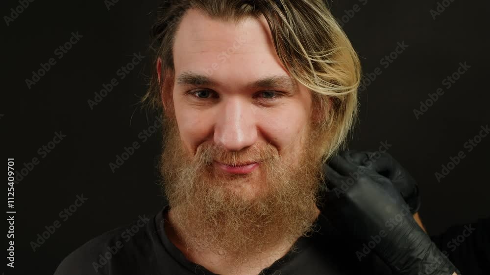 Make up artist making Disheveled blond beard for a man in theater with ...