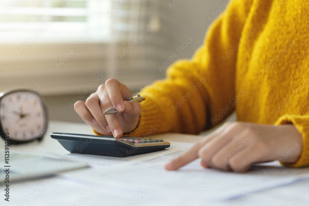 Tax deduction planning concept. Women use a calculator to calculate ...
