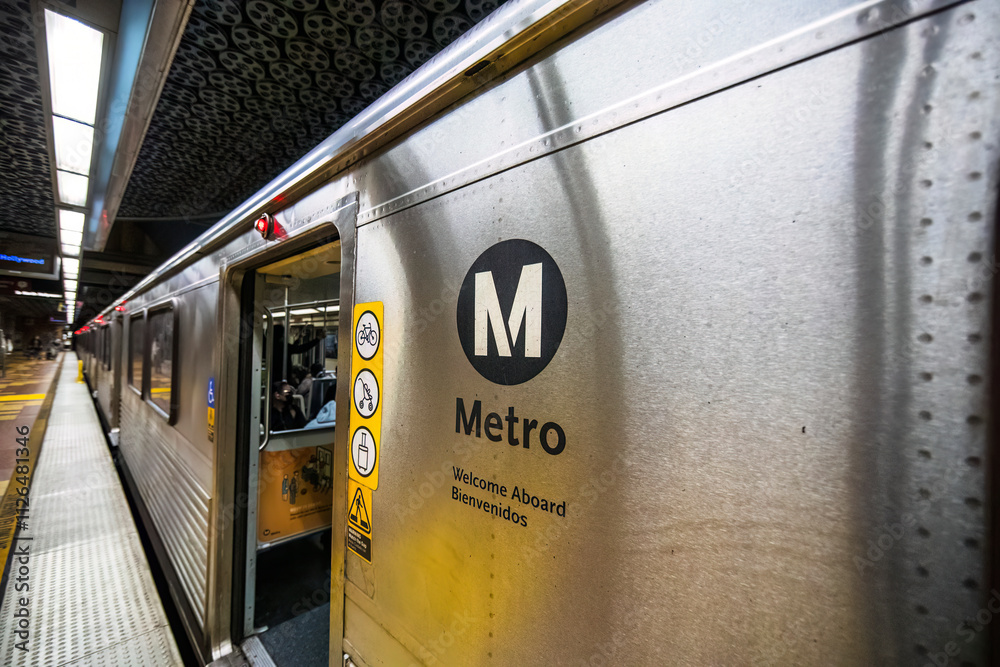 Los Angeles Metro train at the platform, featuring a silver exterior ...
