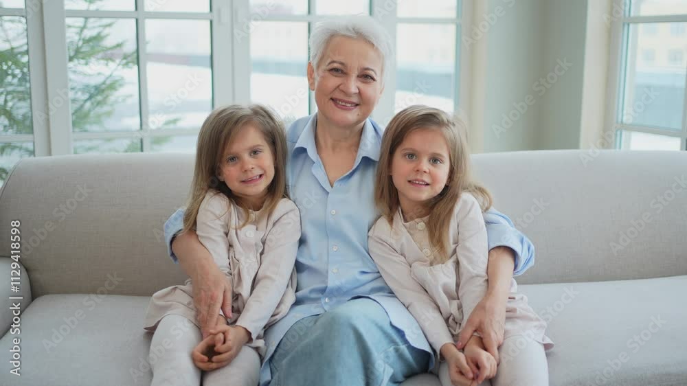 Happy family at home. Two little girls sisters twins grandmother ...