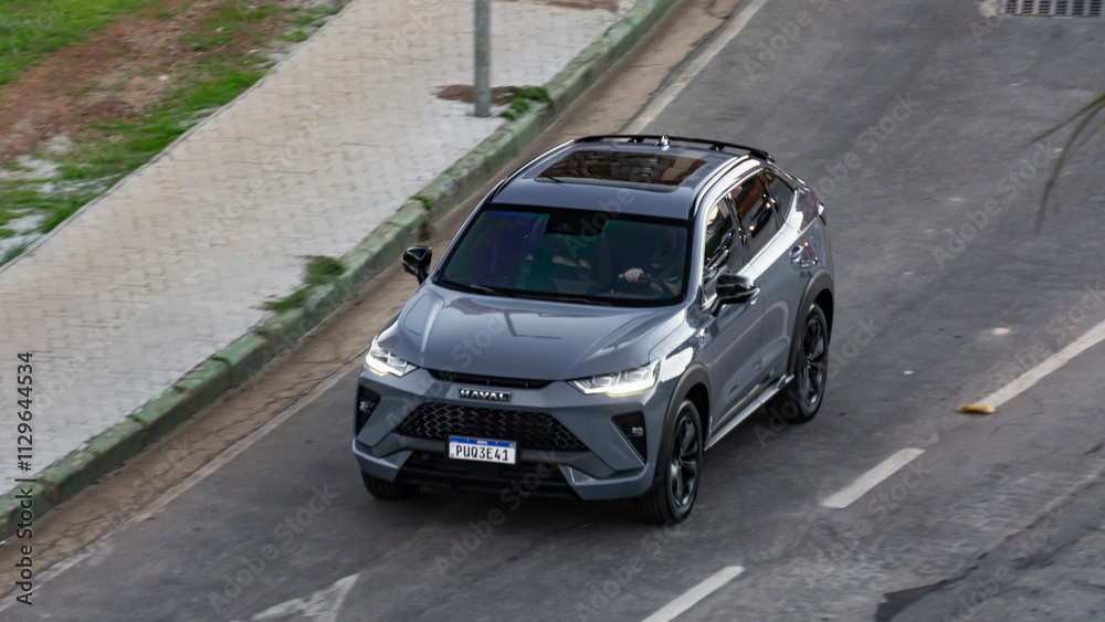 Grey GWM Haval H6 GT in movement, Panning shot of Hybrid SUV in city ...