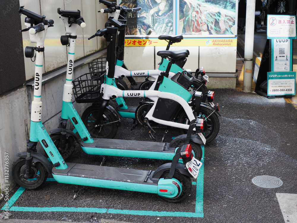 TOKYO, JAPAN - December 7, 2024: Luup rental e-scooters and e-bikes ...