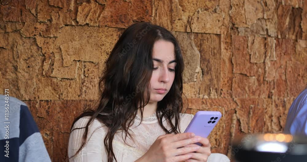 Woman absorbed by smartphone, lost in excessive screen time. Reflects ...