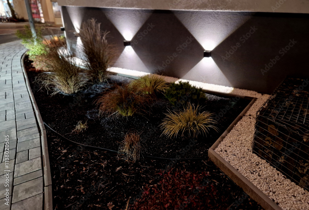 spot wall light illuminates the wall of facade of the house in a ...