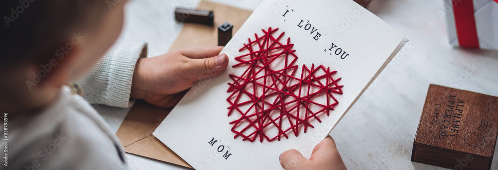 Little kid preparing diy handmade cute post card for Mother's Day with ...