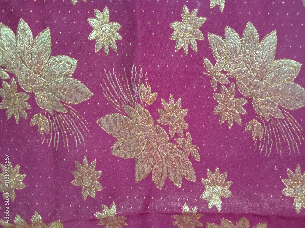 The texture of the fabric is red with a pattern of gold.Songket or ...