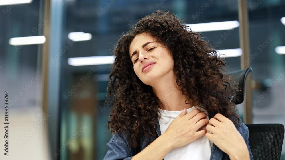 Uncomfortable businesswoman scratches and rubs her itchy skin. Curly ...