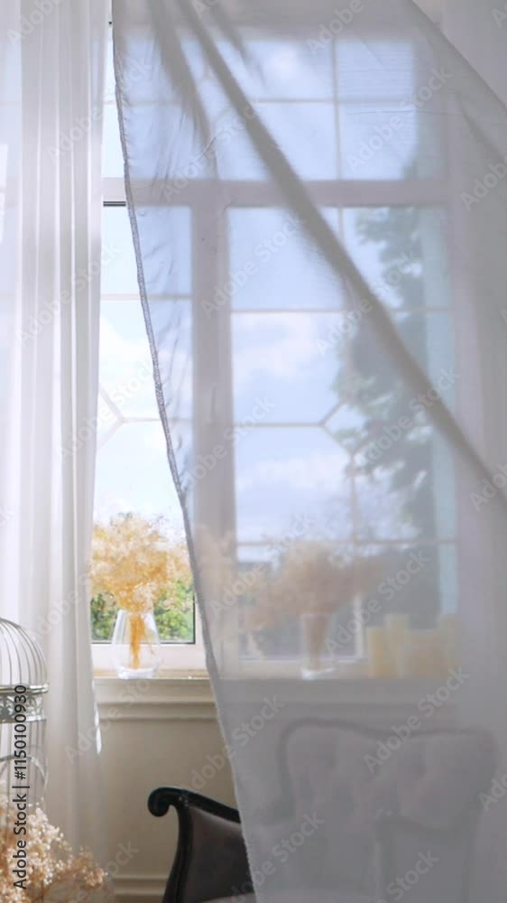 Vertical, Bright room featuring billowing white curtains. Serene room with delicate birdcage and ...