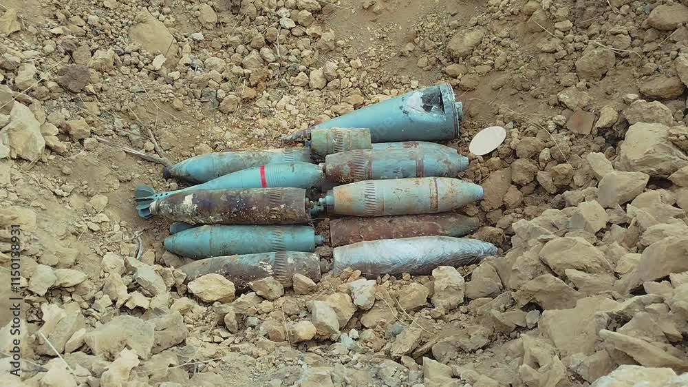 Unexploded shells lie on the ground. Large aerial bombs lie in the ...
