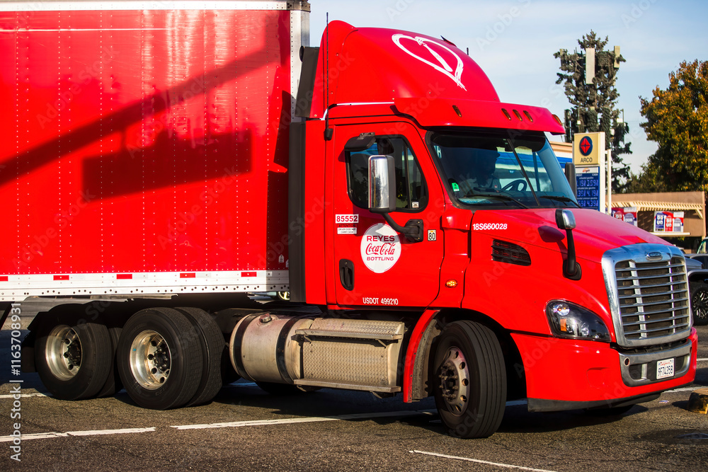 Red Freightliner truck hauls a Coca-Cola trailer featuring the iconic ...