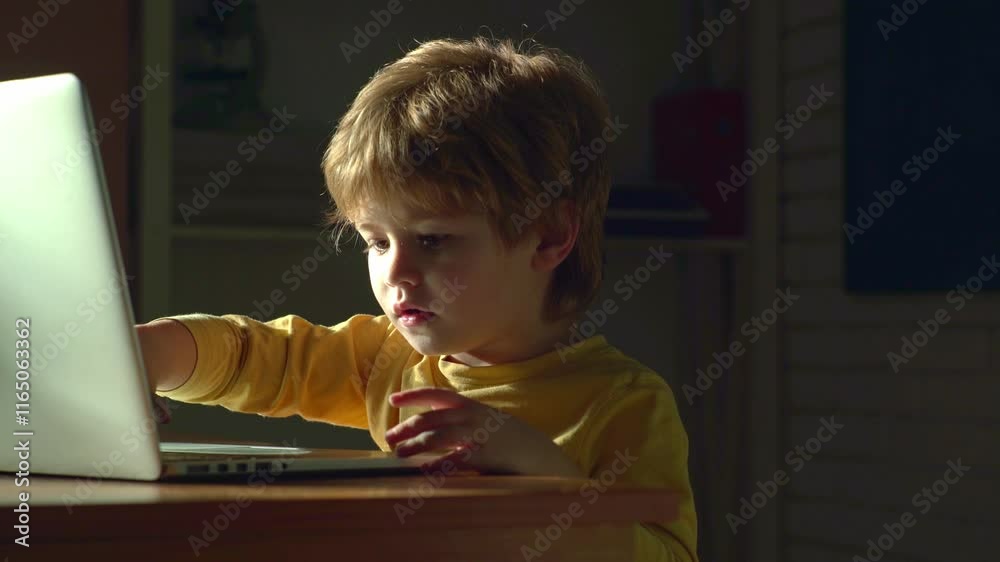 Funny Baby with laptop. Blond baby working with laptop at home. Smart ...