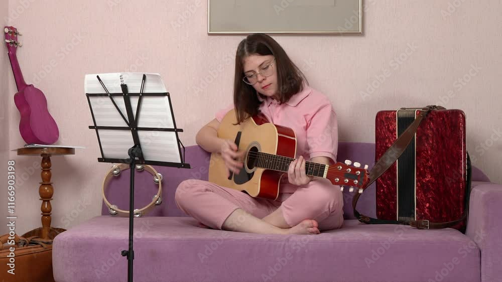 Young woman playing Spanish six string acoustic guitar in strumming ...