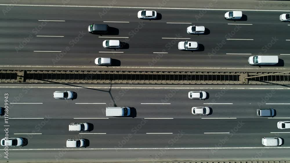 Bird's-eye view of a highway: Vehicles move in two-way traffic with a ...
