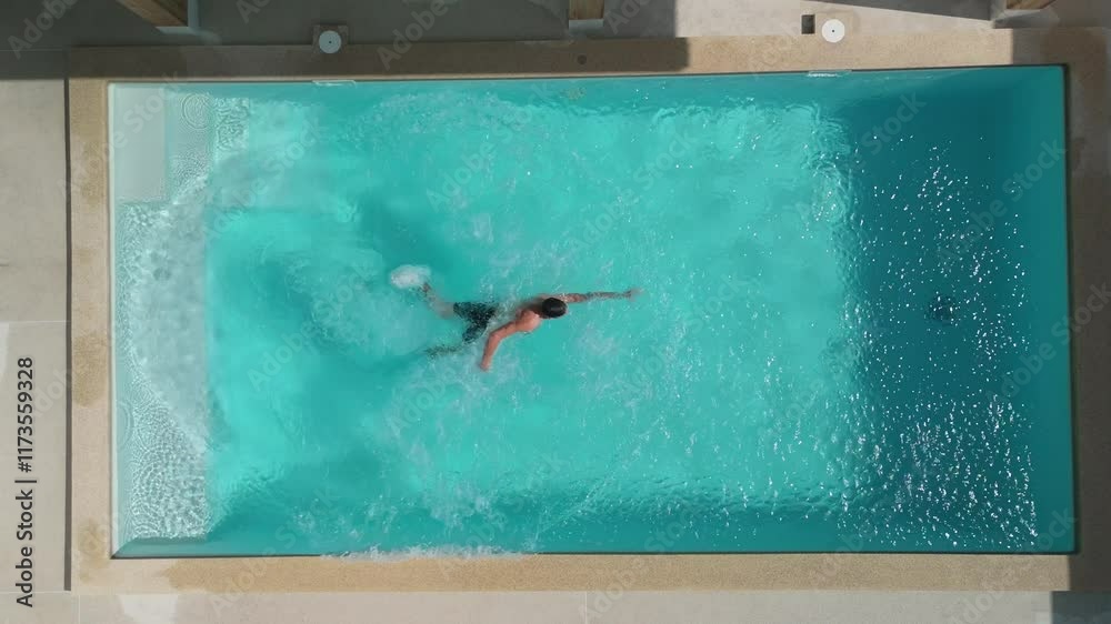 Top view man tourist doing front flip into swimming pool while relaxing ...