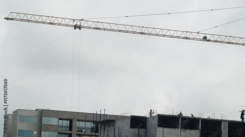 A dynamic scene of construction workers operating around a towering ...