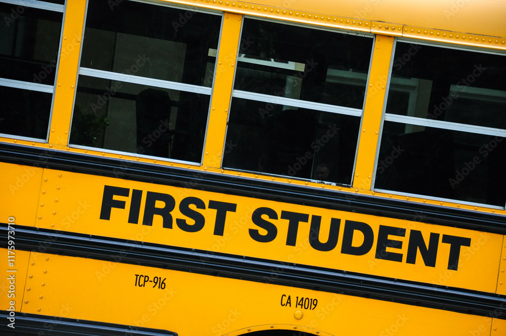 Poster Yellow school bus with 'First Student' logo, showcasing iconic ...