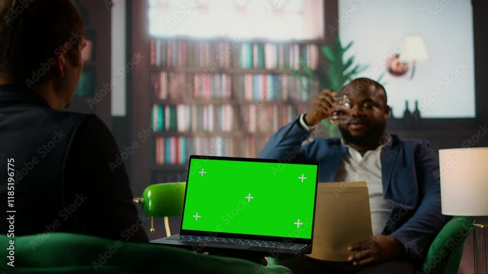 Two secret agents examine case details at CIA safe house with a mockup ...