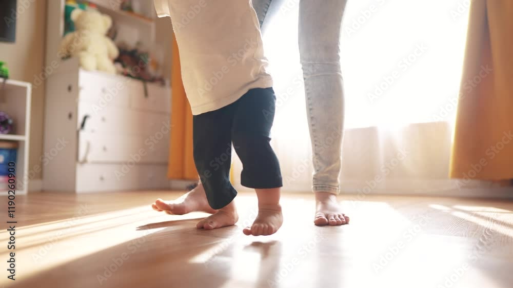 Baby is taking the first steps. happy family kid dream concept. Mom and ...