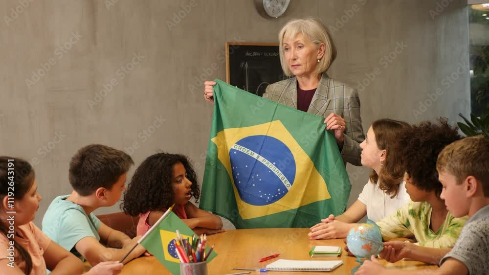Female teacher showing brazilian flag to kids in geography class Stock ...