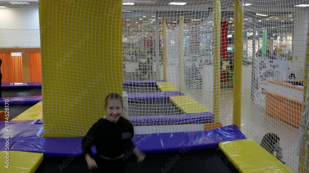 Energetic teen girl fun and jumping on trampoline in entertainment for ...